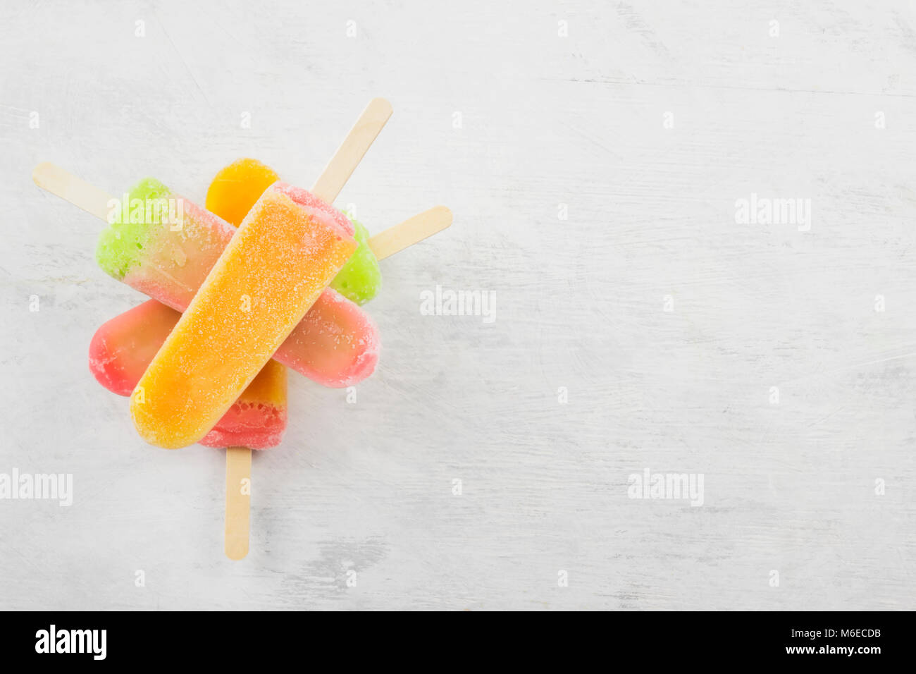 Multi-colored popsicles on a white background. Top view, copy space ...