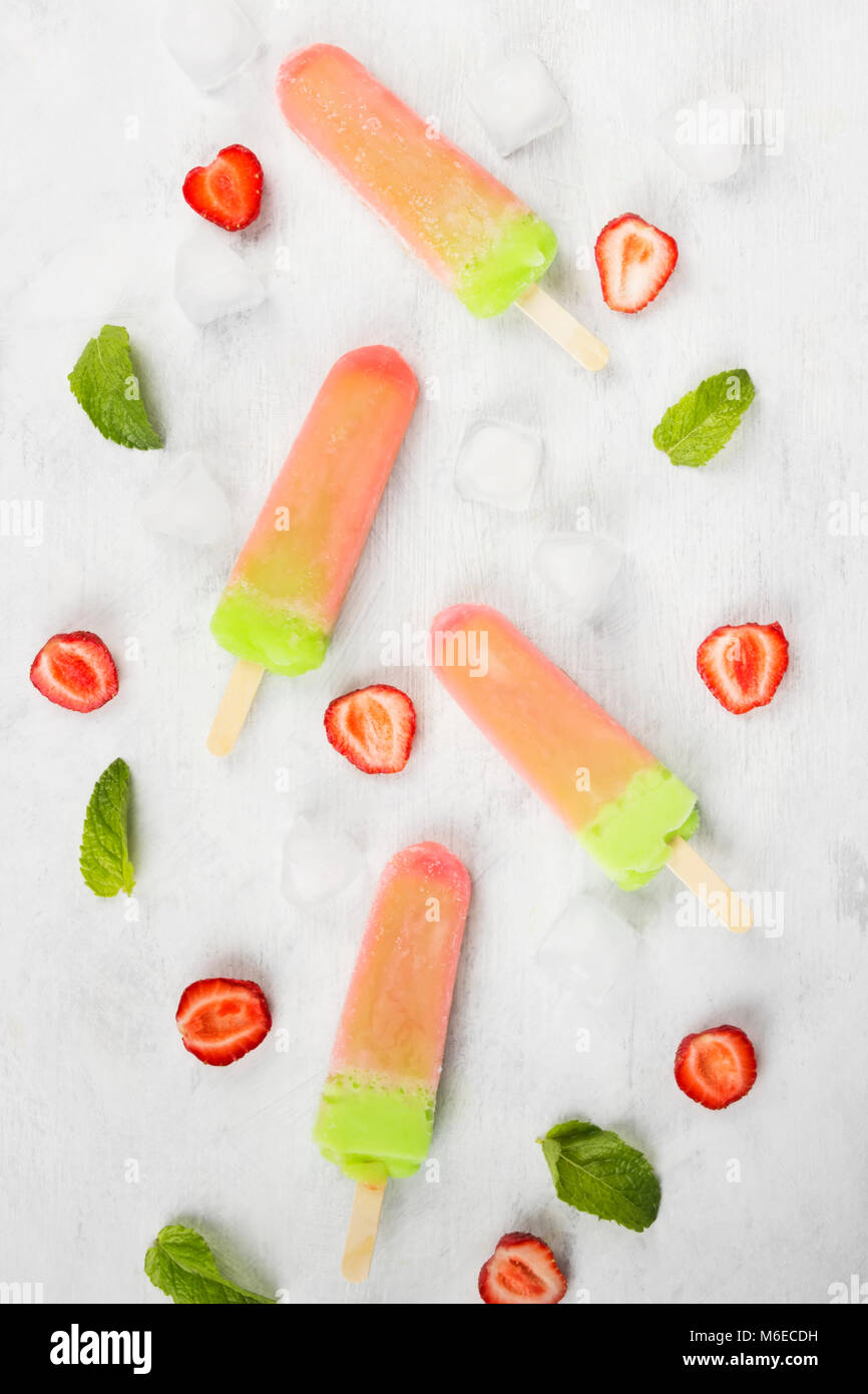 Multi-colored popsicles on a white background. Top view. Food ...