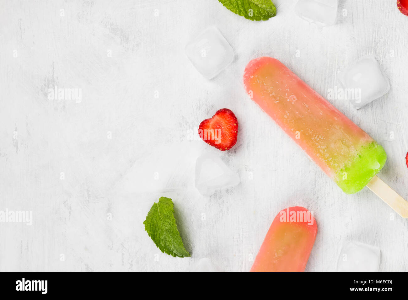 Multi-colored popsicles on a white background. Top view, copy space ...