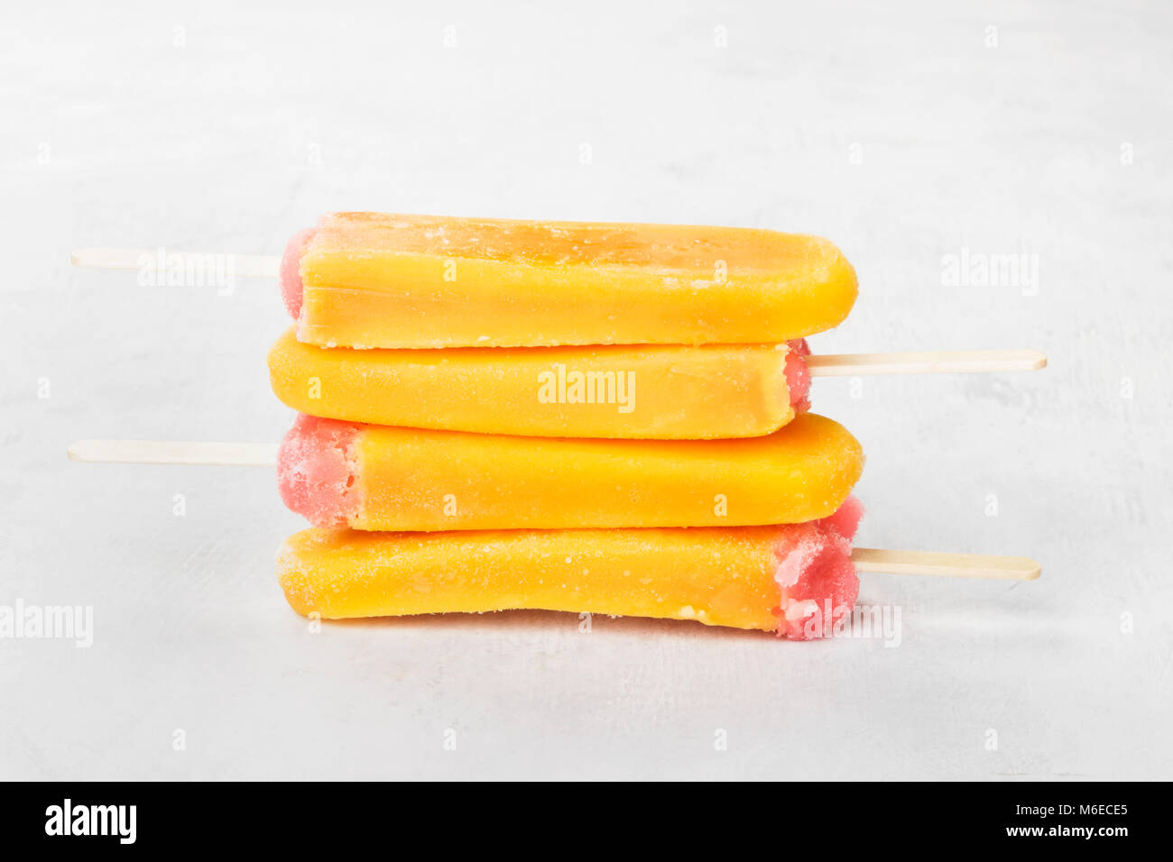 Multi-colored popsicles on a white background Stock Photo - Alamy