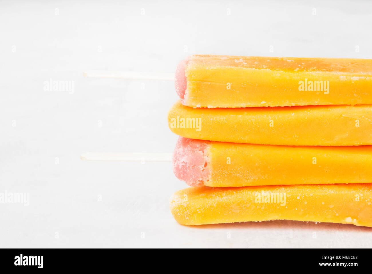 Multi-colored popsicles on a white background. Copy space. Food ...