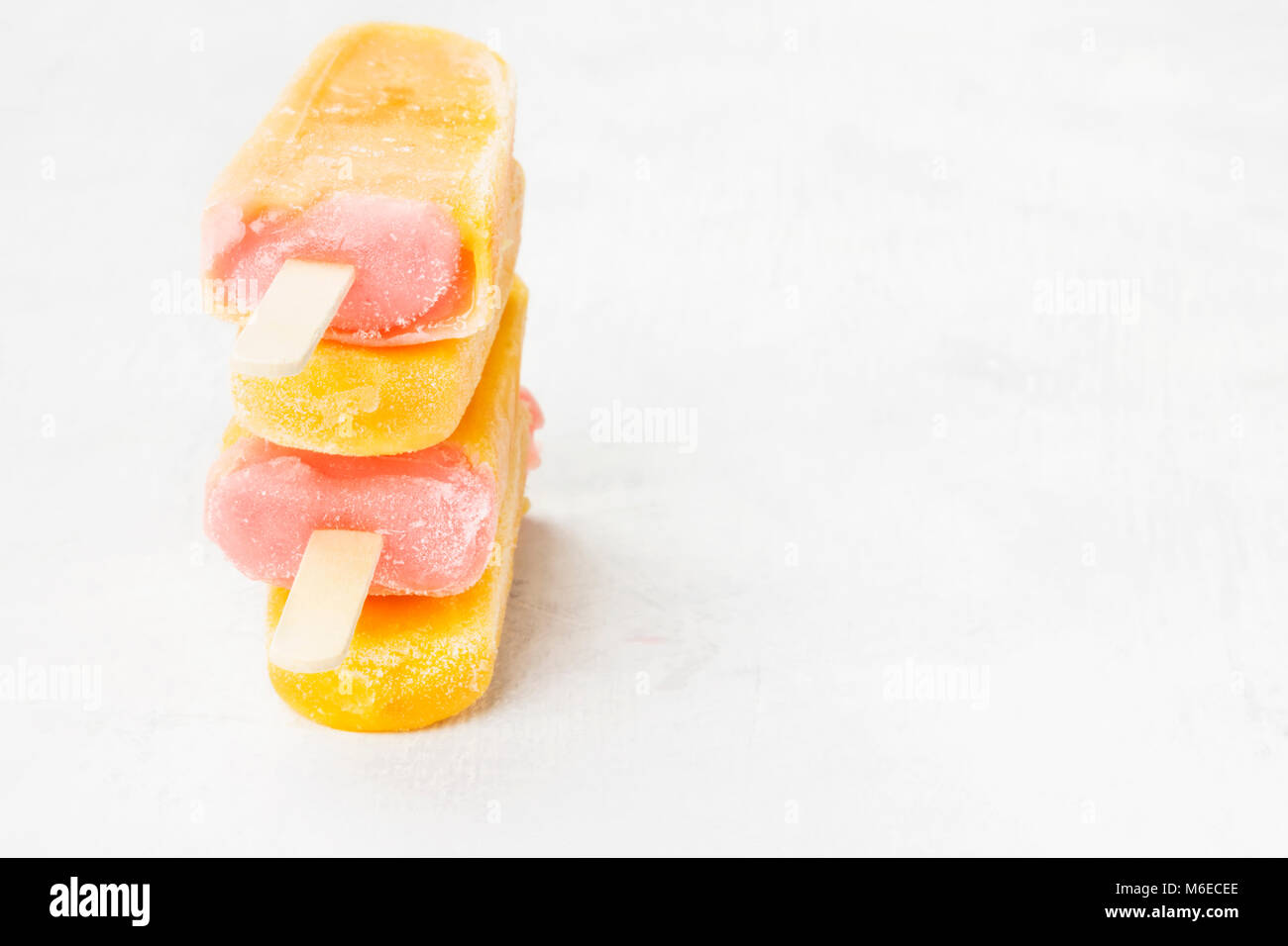 Multi-colored popsicles on a white background. Copy space. Food ...