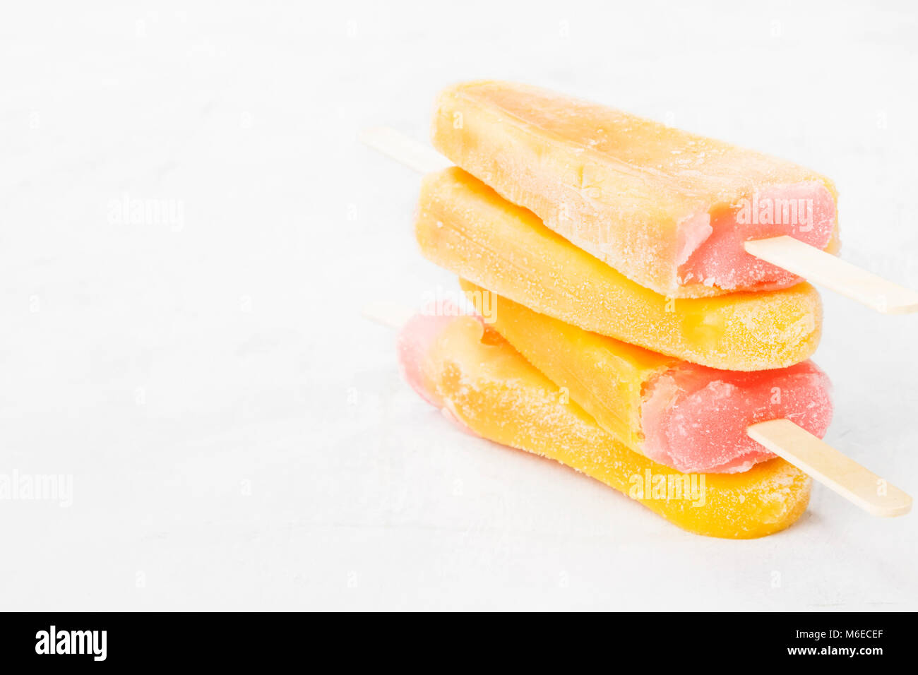 Multi-colored popsicles on a white background. Copy space. Food ...