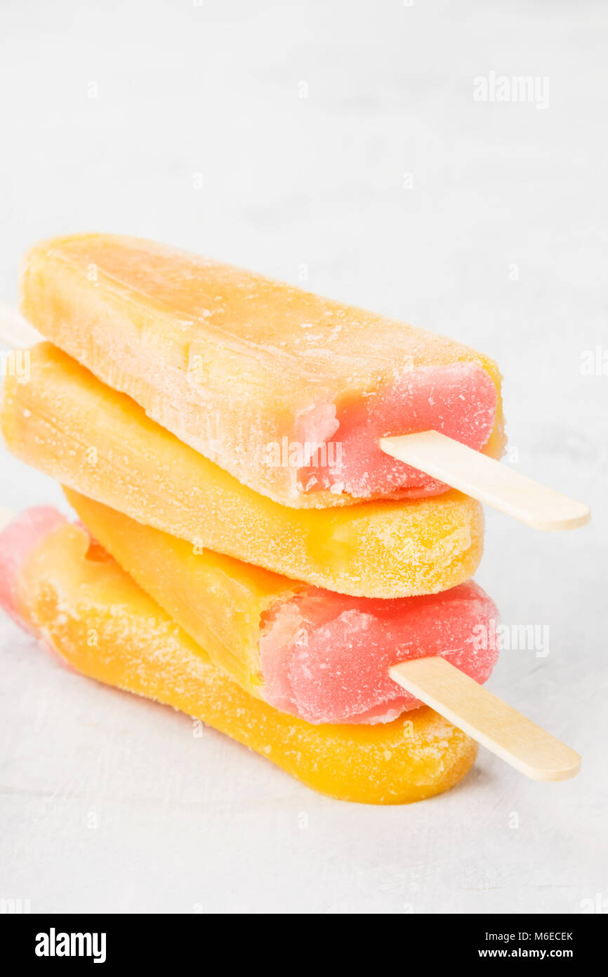 Multi-colored popsicles on a white background Stock Photo - Alamy