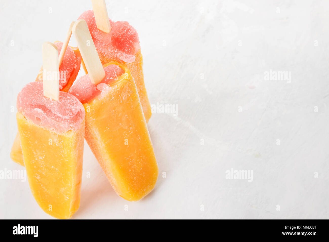 Multi-colored popsicles on a white background. Copy space. Food ...