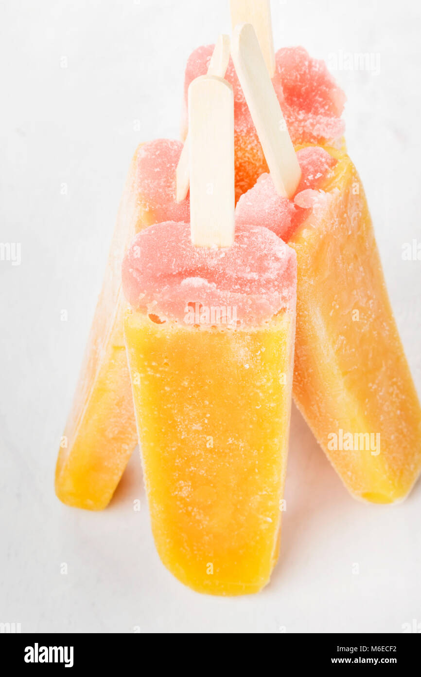 Multi-colored popsicles on a white background Stock Photo - Alamy