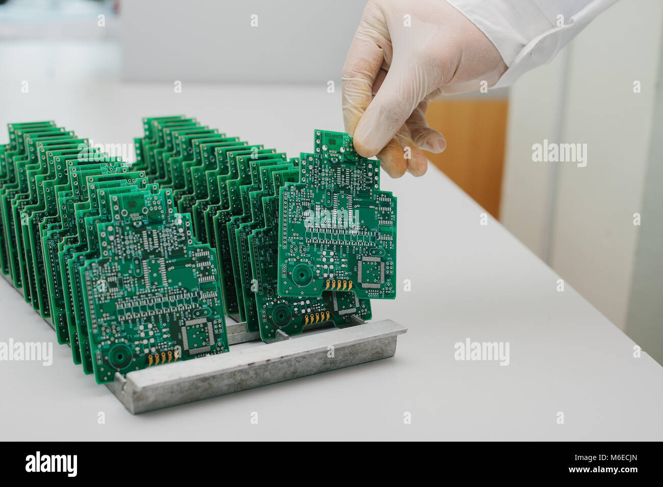 The technician takes a computer board with chips. Spare parts and ...