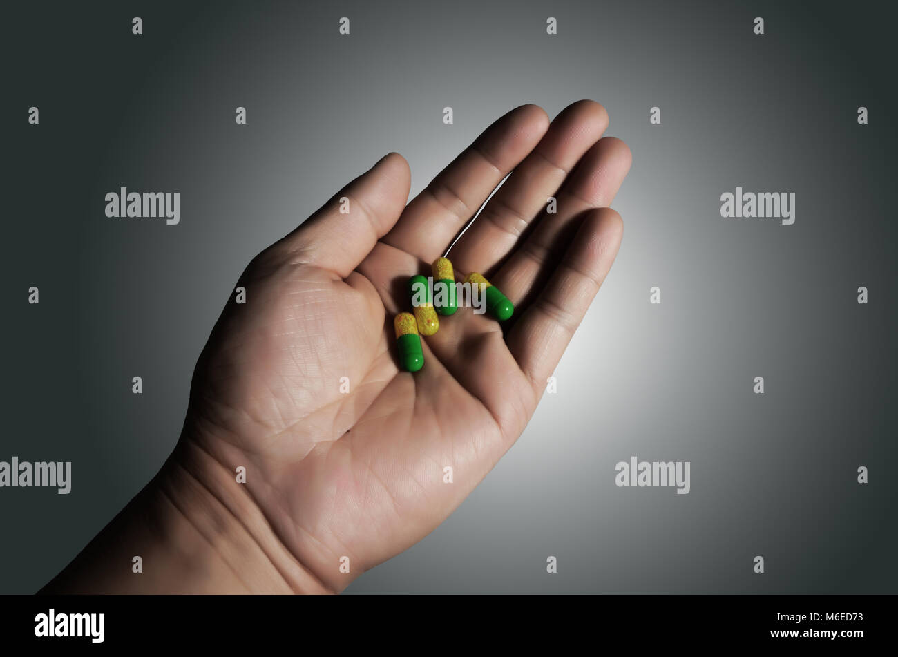 Pills on the palm, treat diseases Stock Photo - Alamy