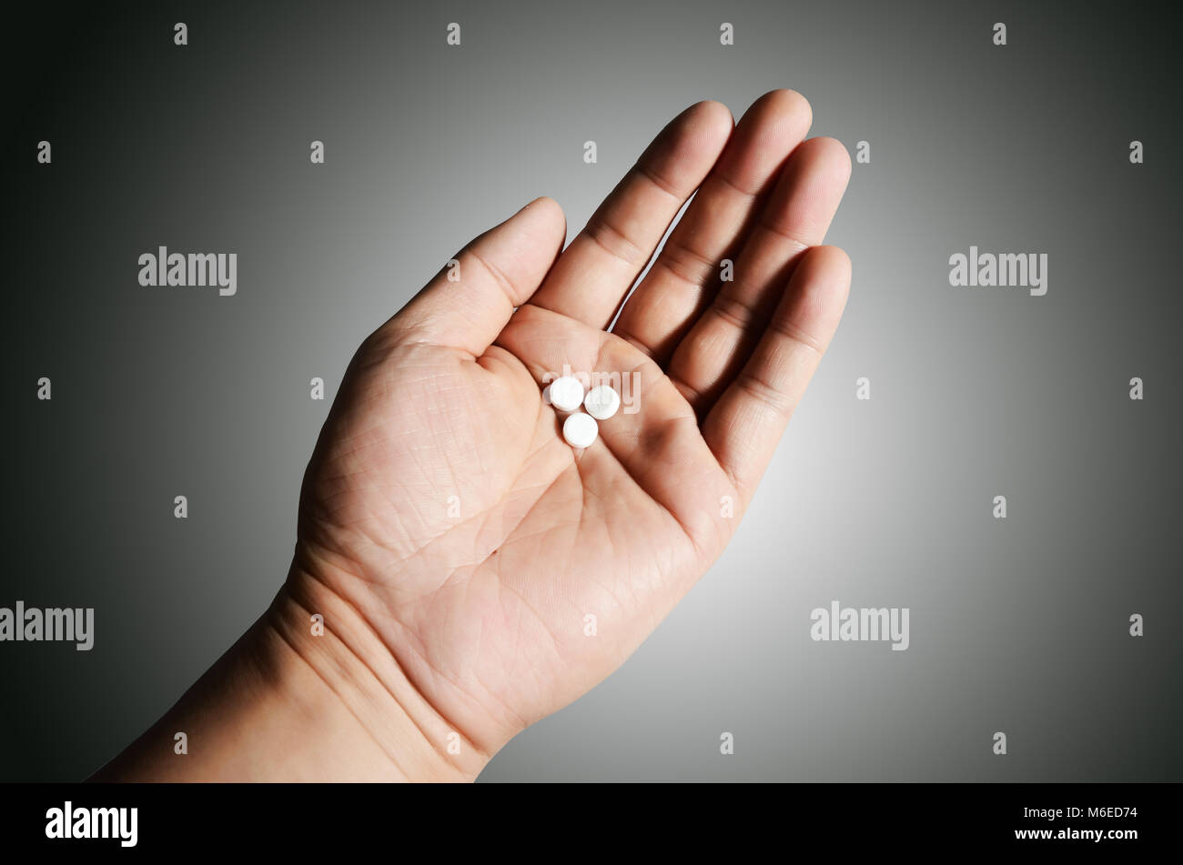 Pills on the palm, treat diseases Stock Photo - Alamy