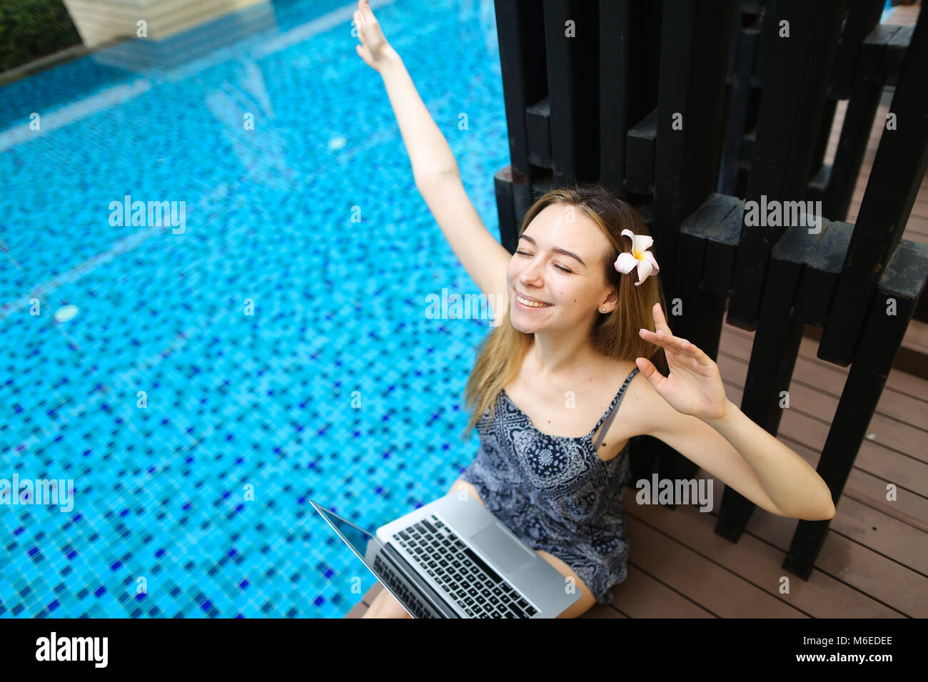 Sunny portrait of female stretches hands And laptop keyboard aft Stock ...