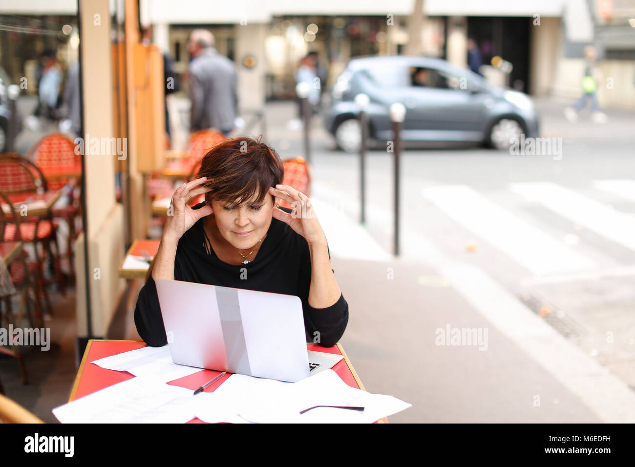 aged female screenwriter working with scenario in laptop Stock Photo ...