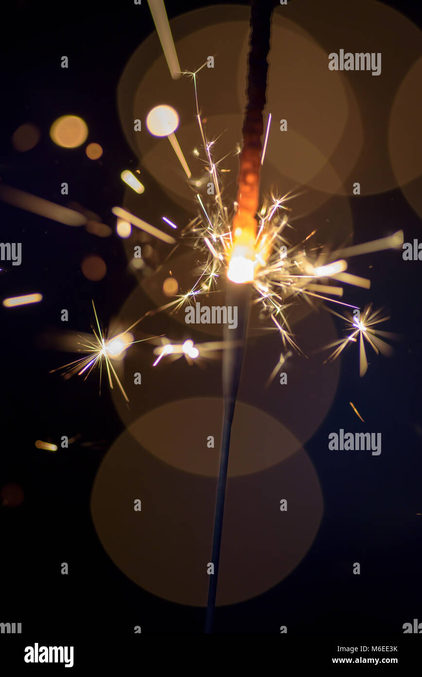 beautiful macro closeup of a single sparkler glowing and sparking at ...