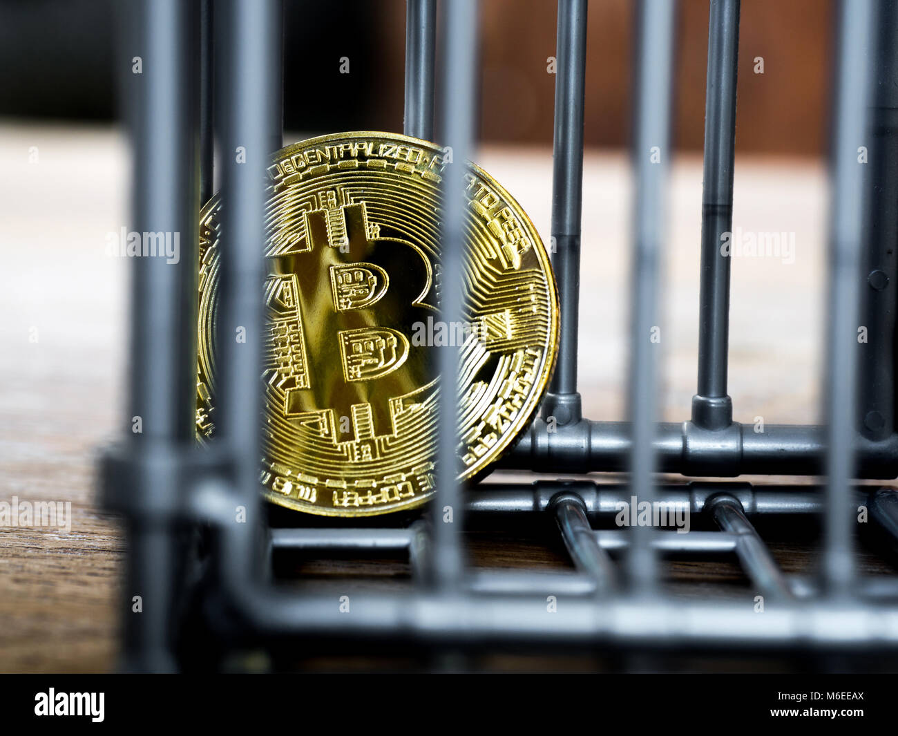 The coin is in the gray nick color put on a wooden table. The concept ...