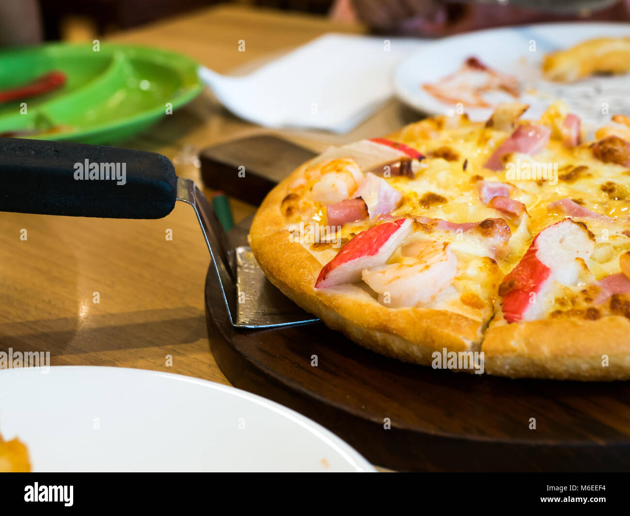 seafood pizza topping whit Crab, shrimp and ham On a wooden tray. The ...