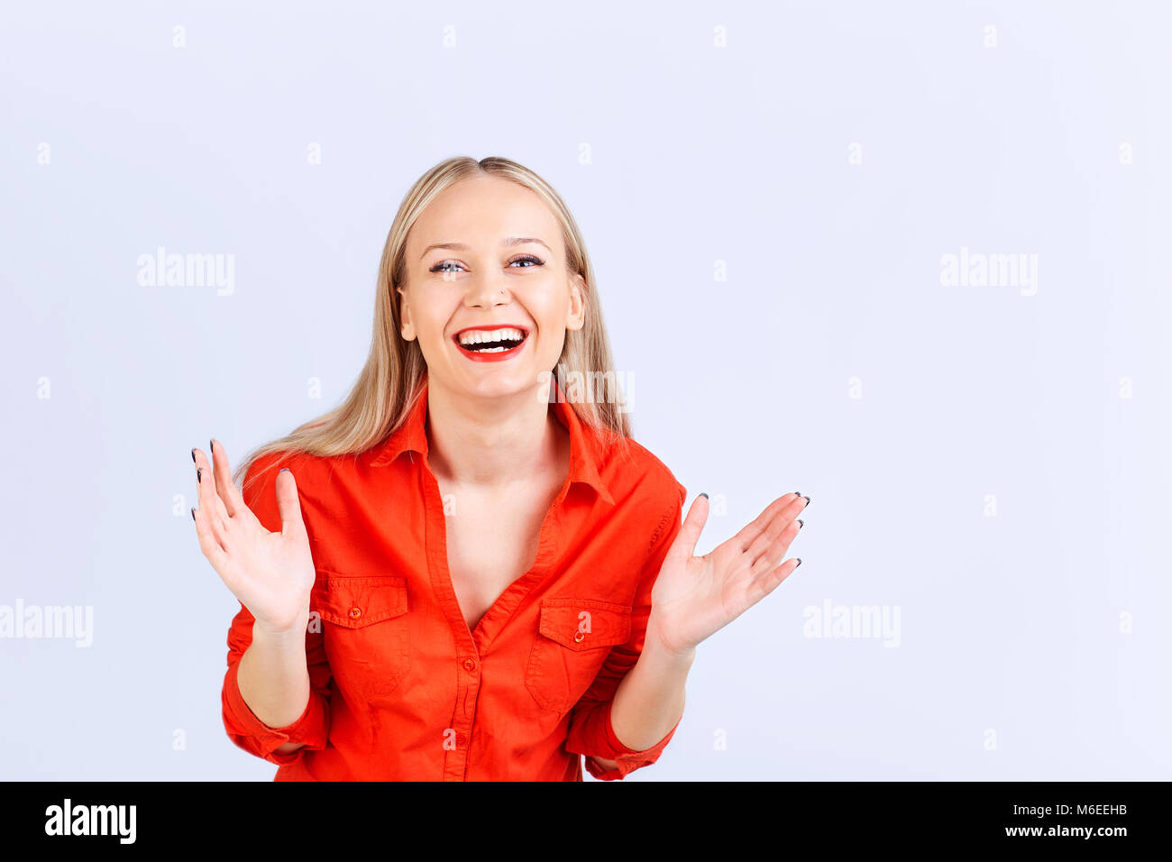 Young blonde woman in casual clothing laughing with positive emotion on ...