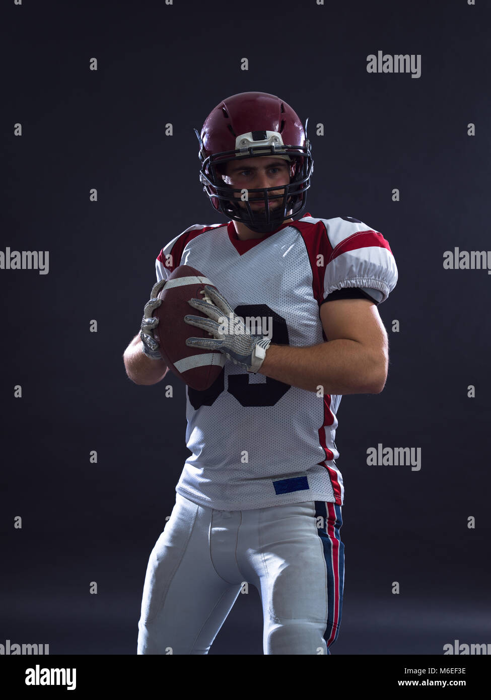 one quarterback american football player throwing ball isolated on gray ...