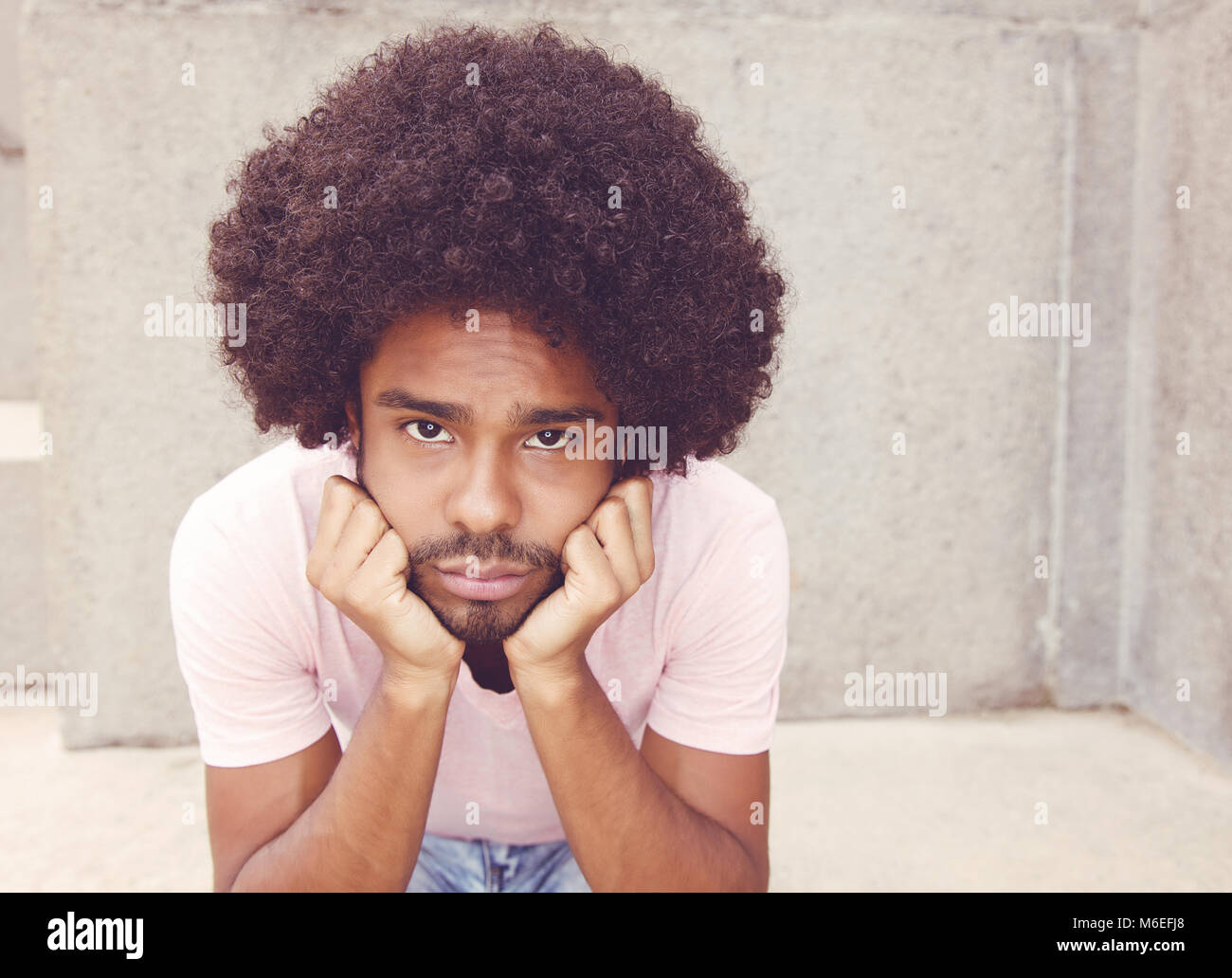 Poor and sad african american hipster man looking at camera outdoors in ...