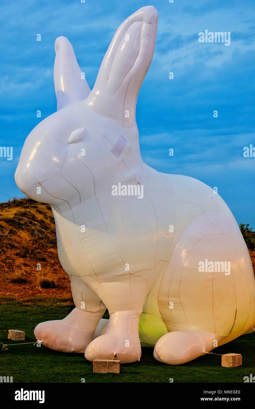 Giant Inflated White rabbit tied with ropes Stock Photo - Alamy