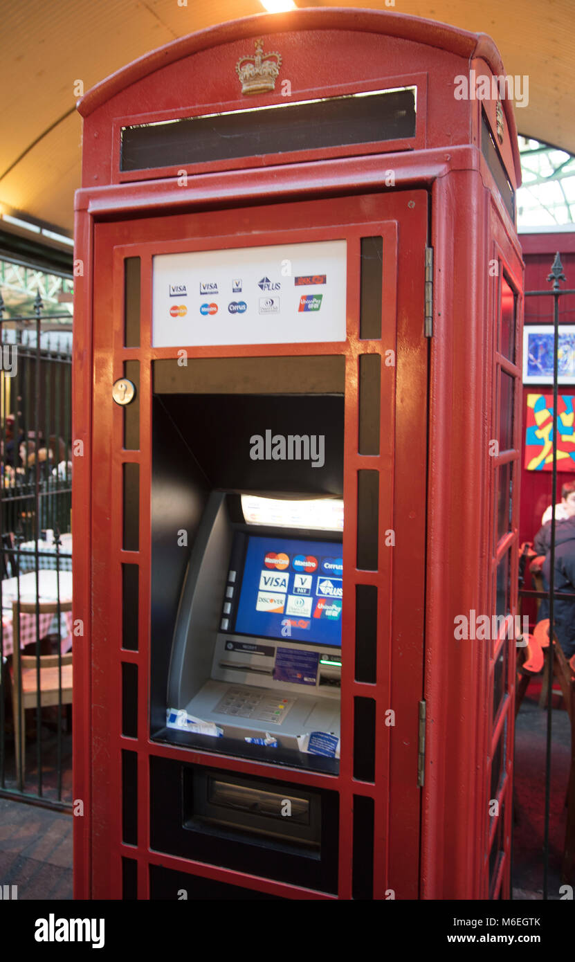 ATM machine fitted into a converted red telephone box Stock Photo - Alamy