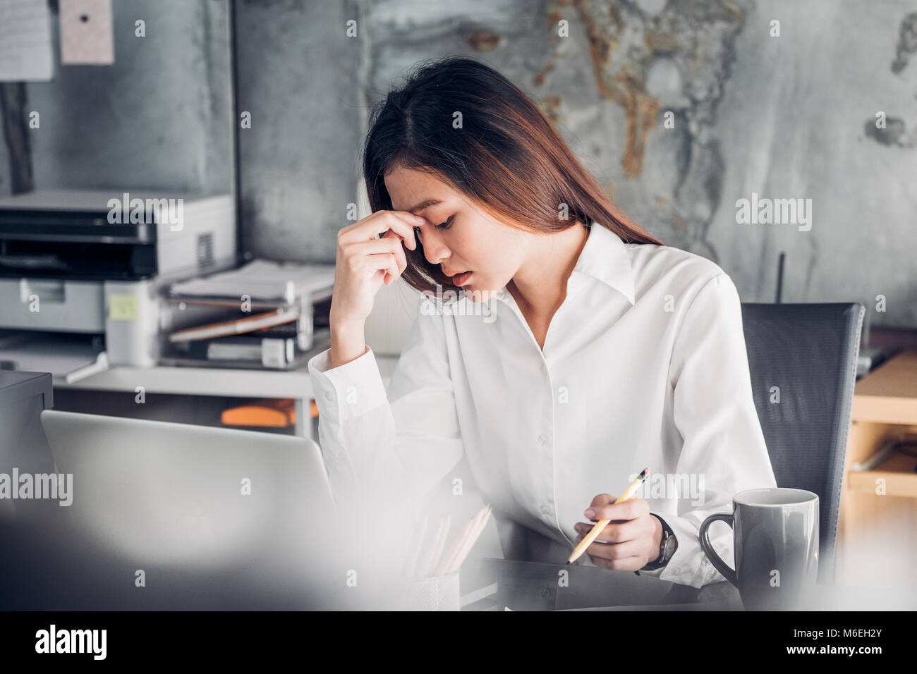 Frustrated Asian businesswoman cover her face with two hand and feel ...