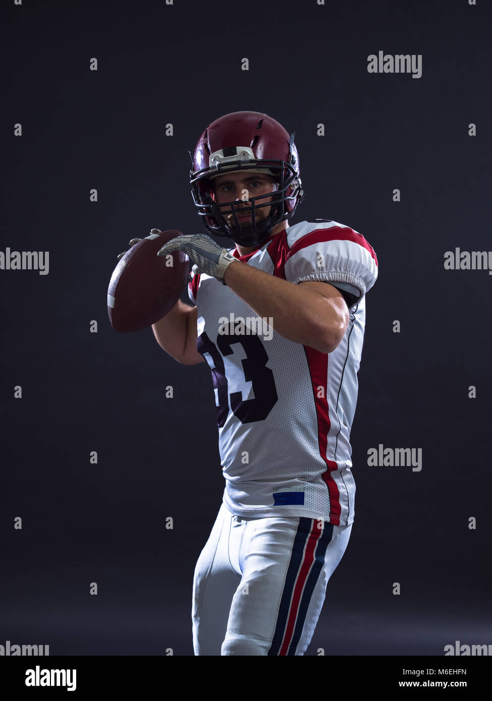 one quarterback american football player throwing ball isolated on gray ...