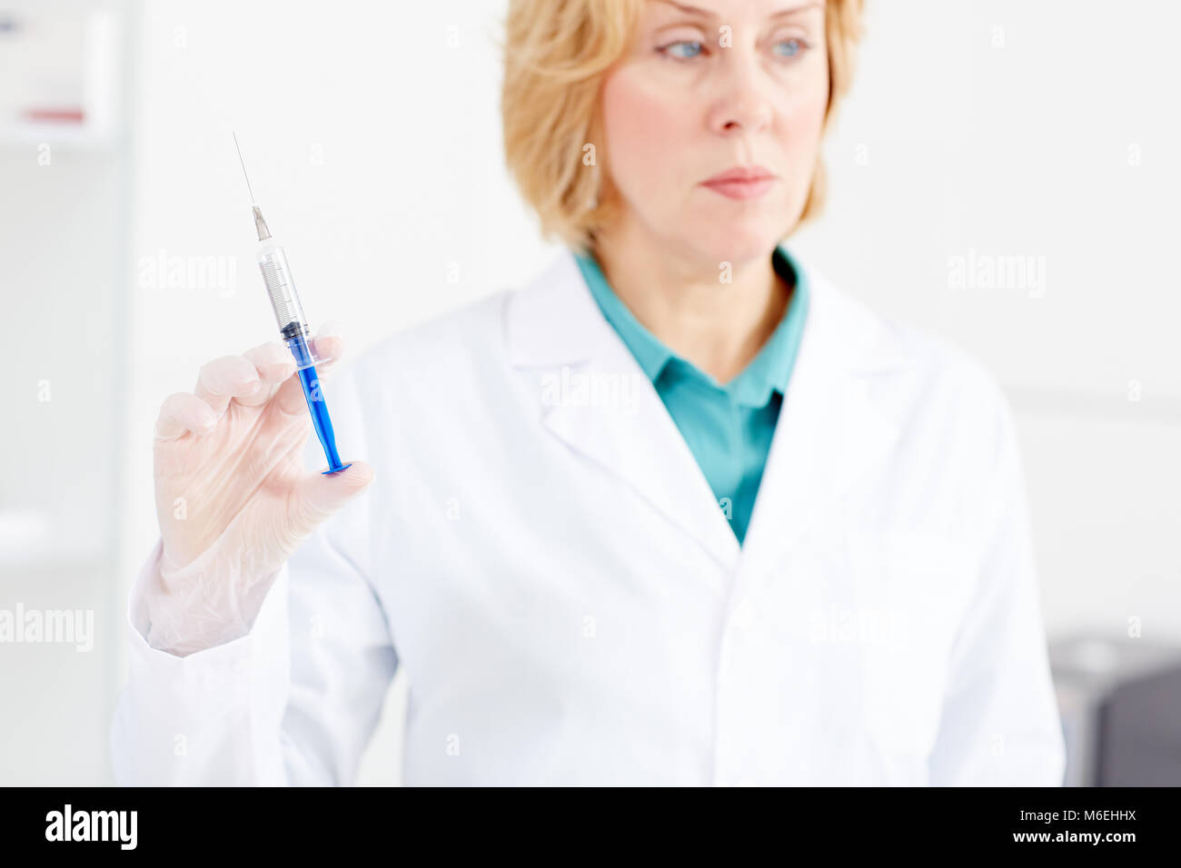 Doctor with injection Stock Photo - Alamy