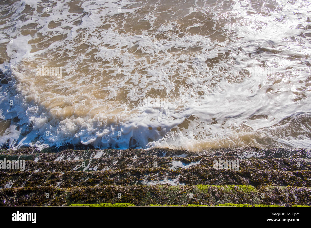The high tide on the waterfront path near Broadstairs with the sea ...