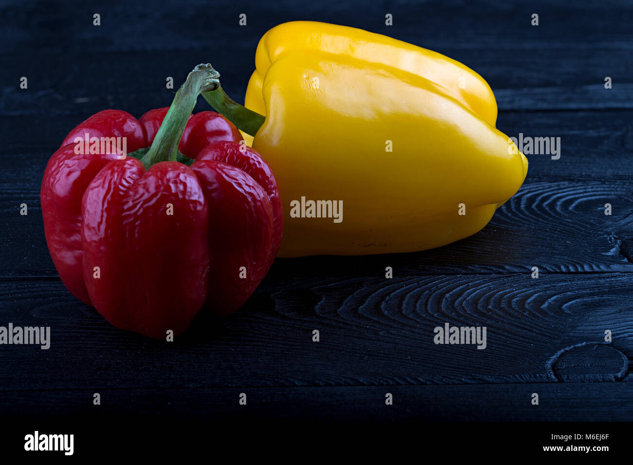 Pepper on a wooden table, copy space Stock Photo - Alamy