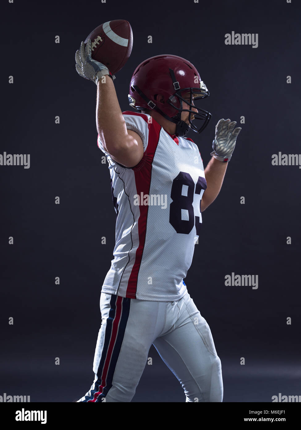 one quarterback american football player throwing ball isolated on gray ...
