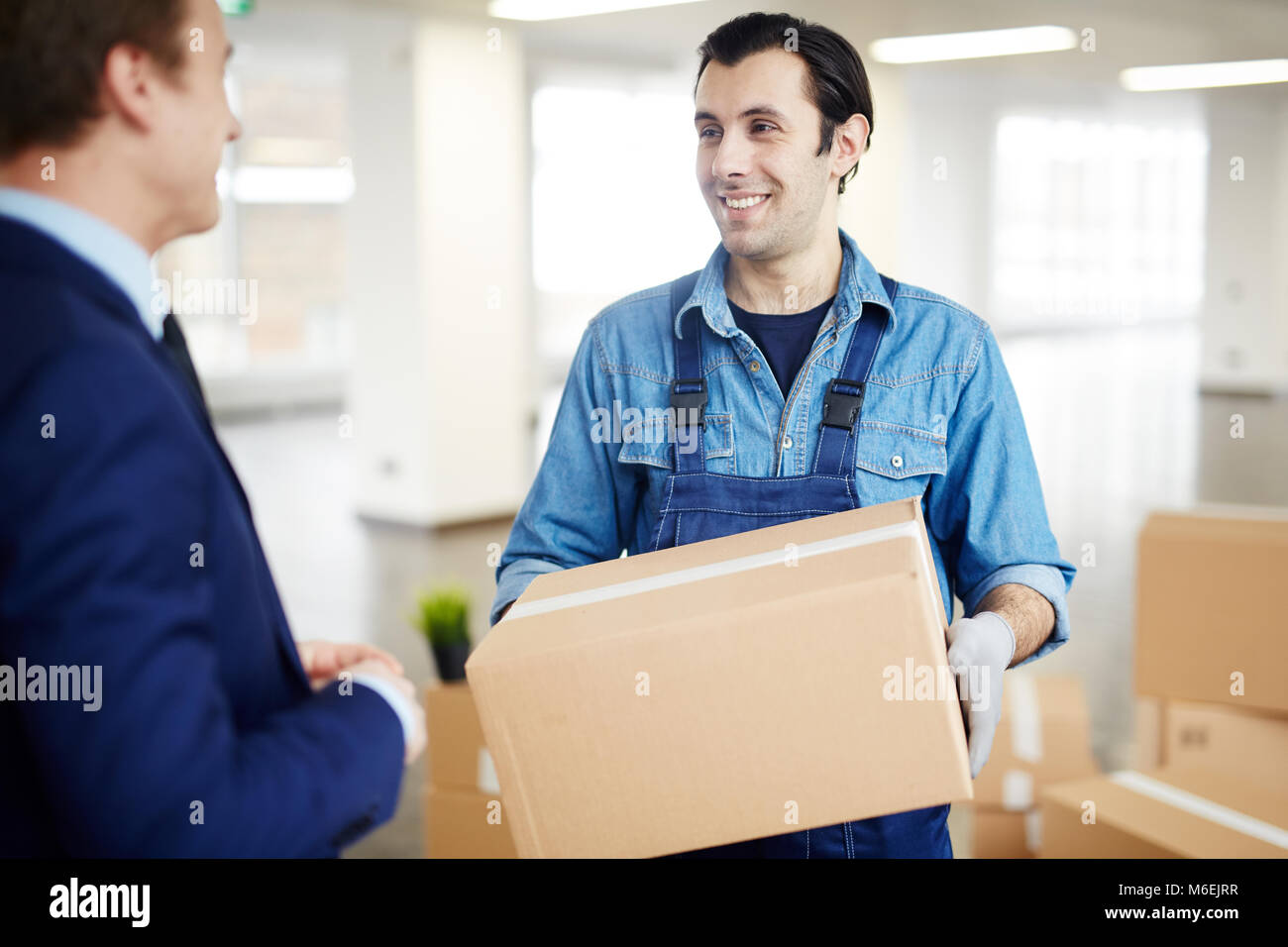 Delivery man with box Stock Photo - Alamy