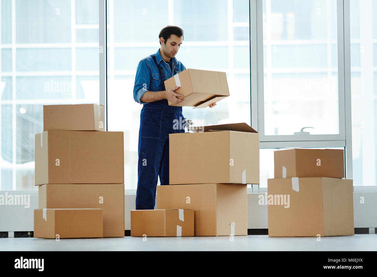 Putting boxes in stacks Stock Photo - Alamy