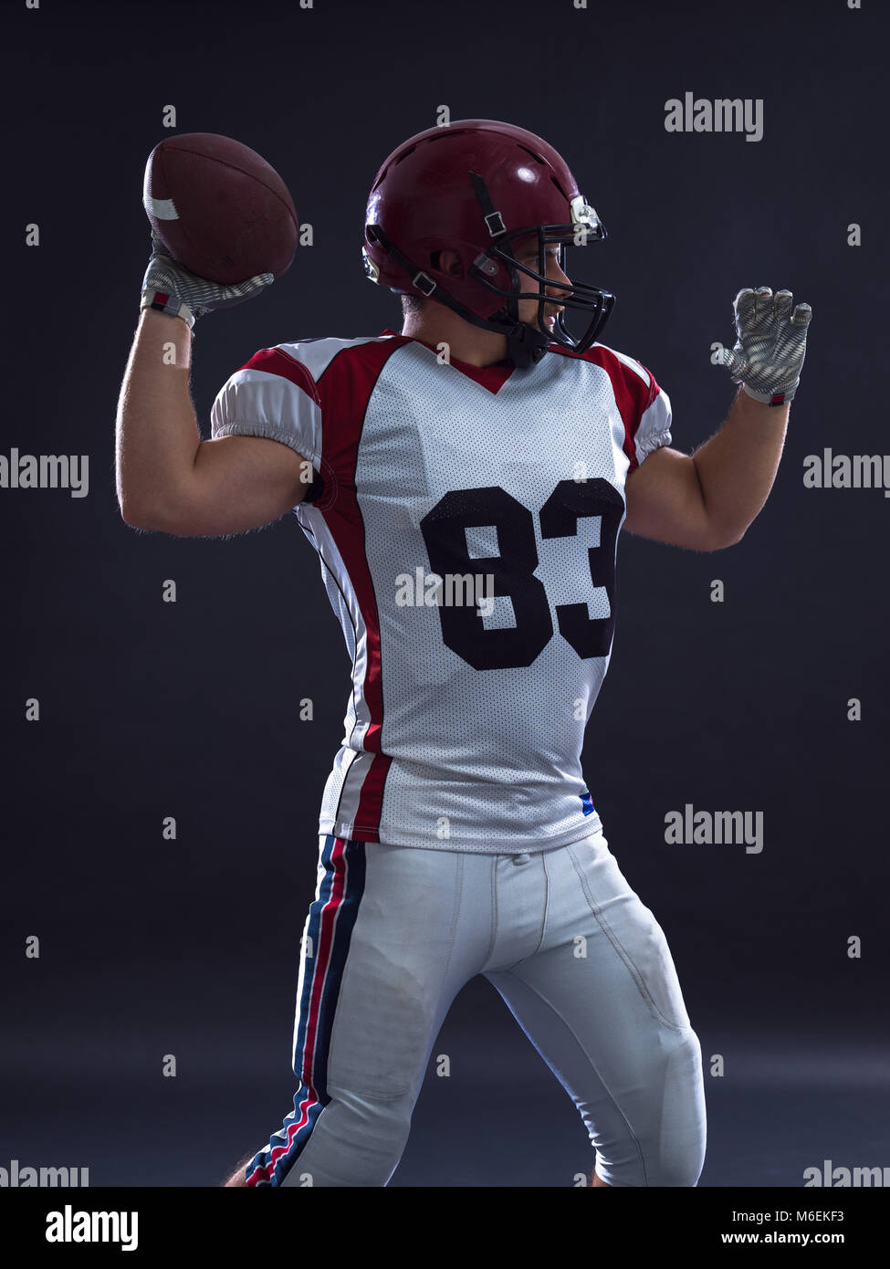 one quarterback american football player throwing ball isolated on gray ...