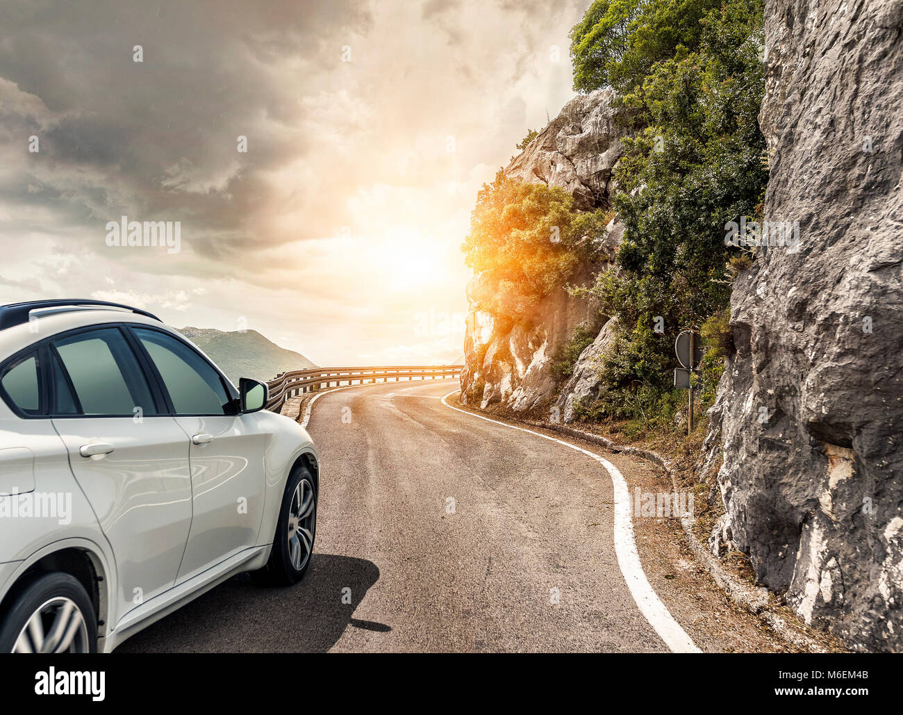 A white car rushing along a high-speed highway in the sun Stock Photo ...