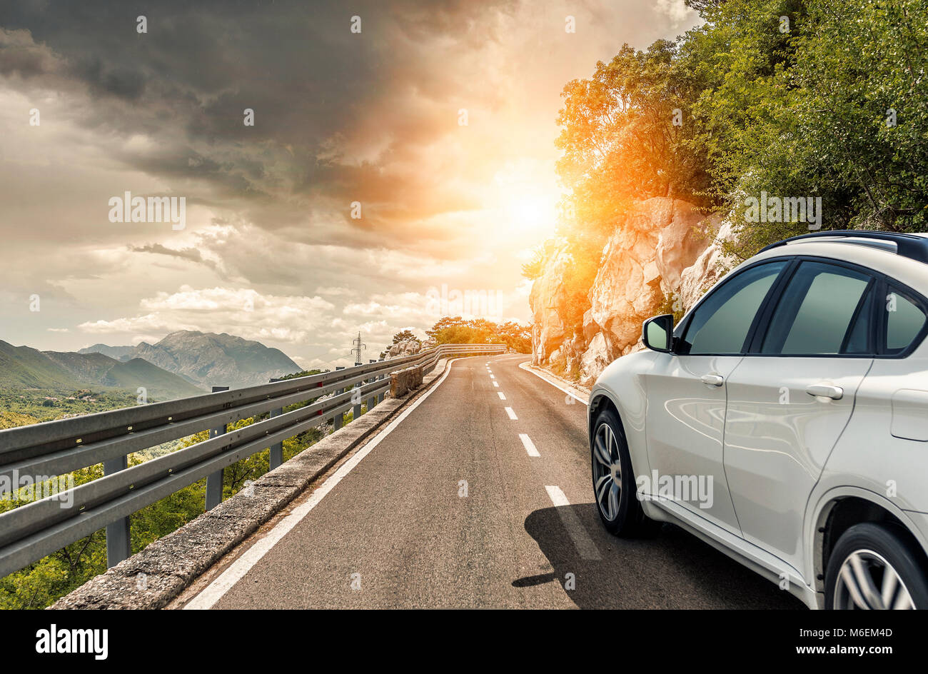 A white car rushing along a high-speed highway in the sun Stock Photo ...