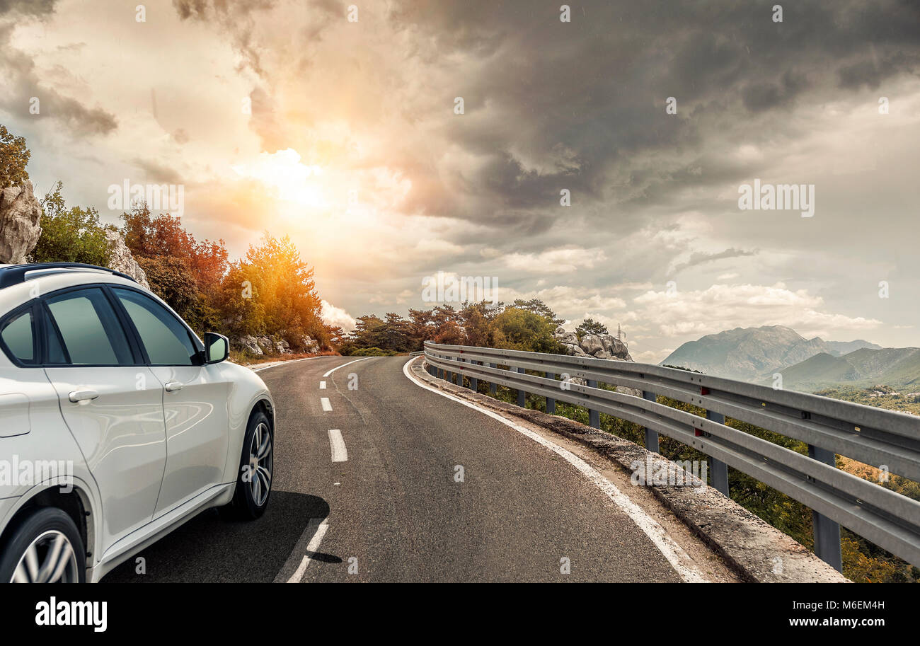 A white car rushing along a high-speed highway in the sun Stock Photo ...