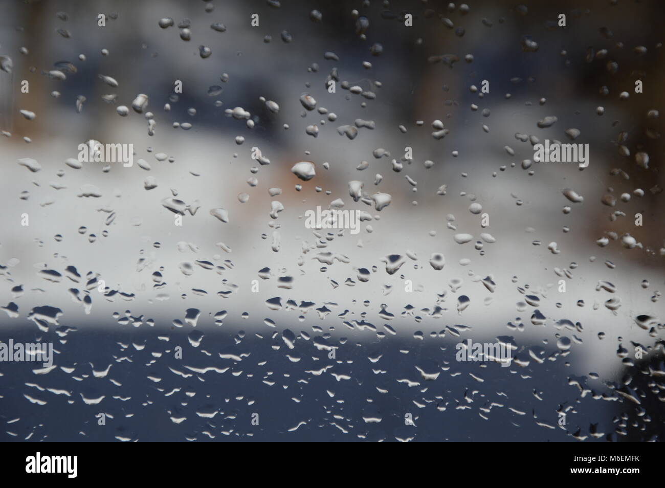 Rain drops on the window with forest background Stock Photo - Alamy