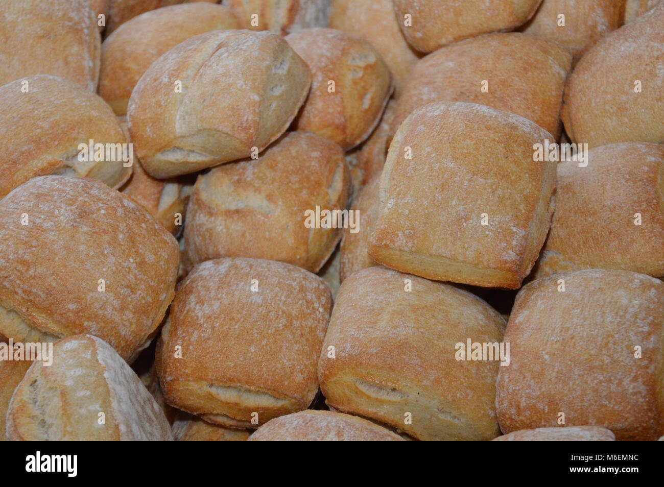 Zoom on a filled basket with small bread Stock Photo - Alamy