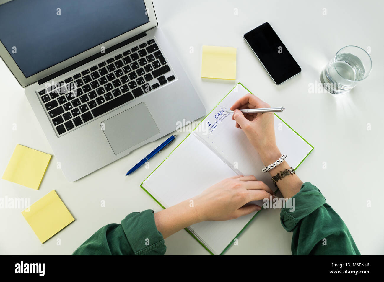 Working at desk with notepad and laptop computer Stock Photo - Alamy
