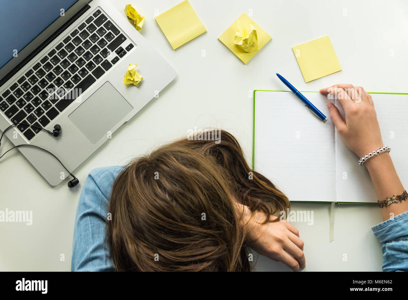 Tired person at home office desk top view Stock Photo - Alamy