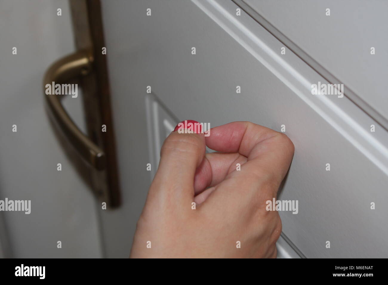 Female Hand knocking on door Stock Photo - Alamy