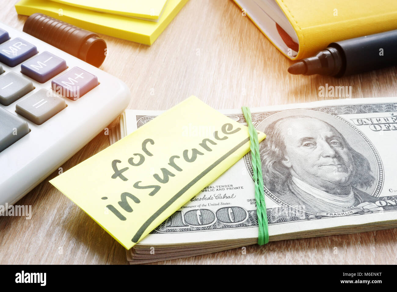 Memo with word for insurance on a stack of money Stock Photo - Alamy