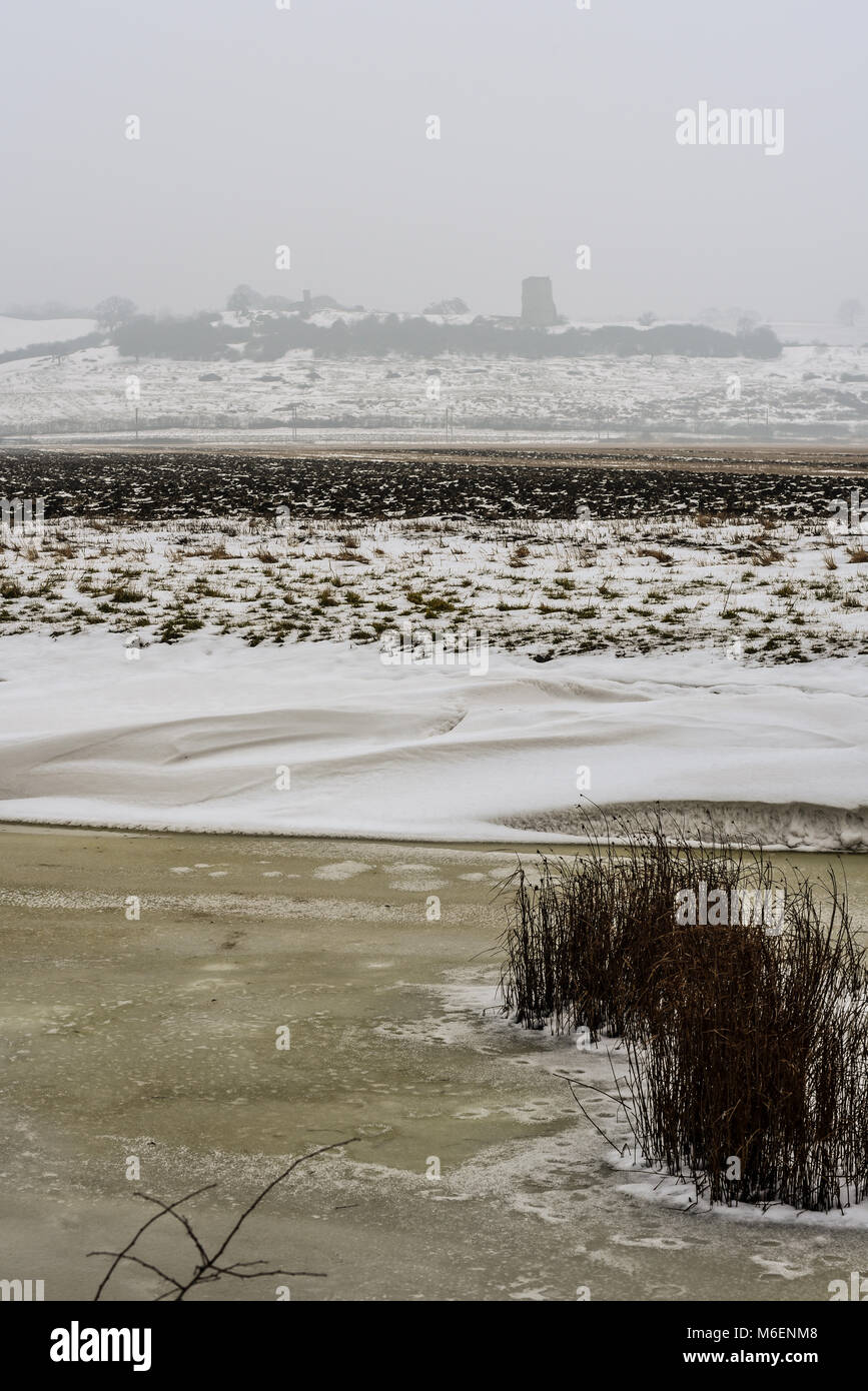 Frozen river and snow covered fields of Hadleigh Marsh with Hadleigh ...