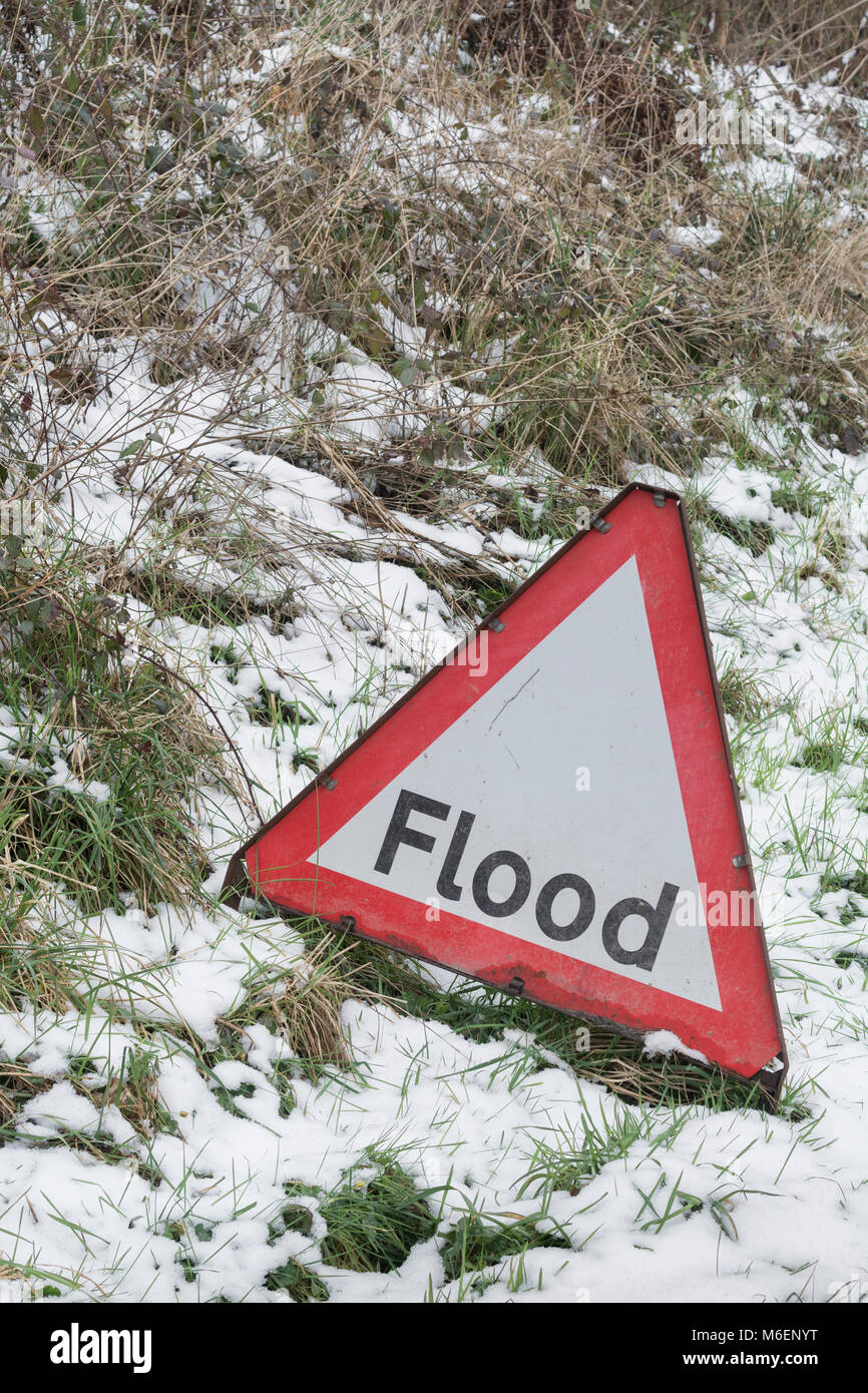 The anomaly of a red flood warning road sign during the snows of the ...