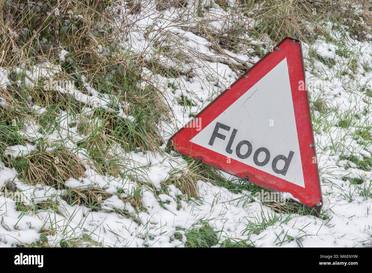 The anomaly of a red flood warning road sign during the snows of the ...