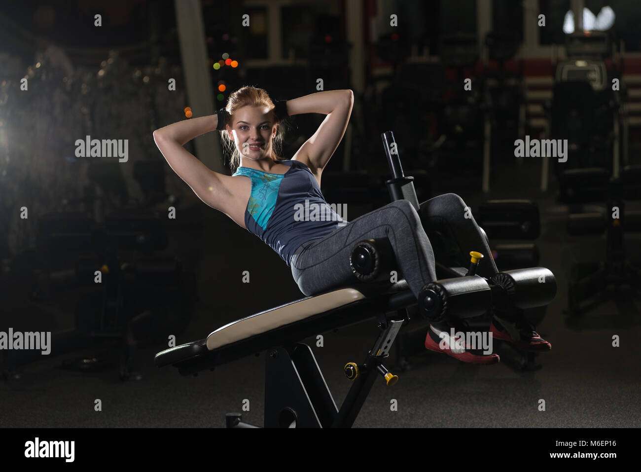 Woman doing strength exercises for abs muscles Stock Photo - Alamy
