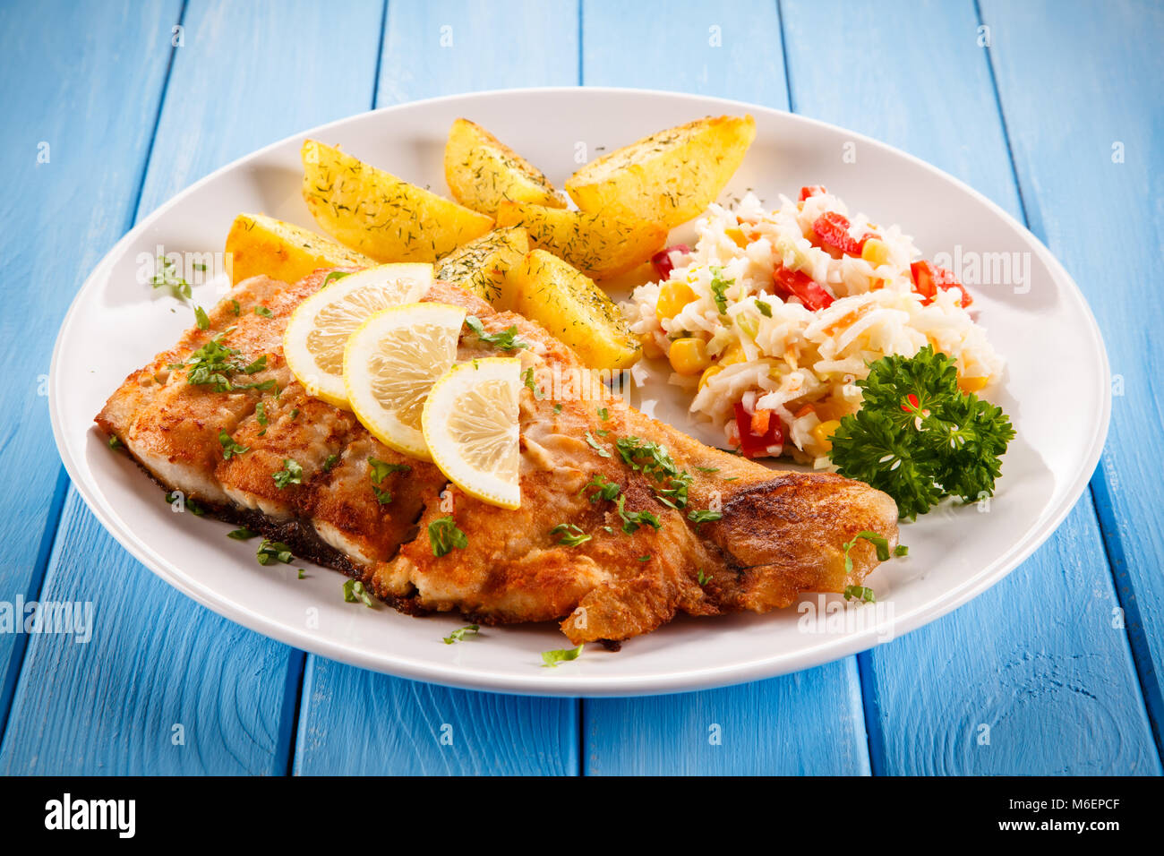 Fish dish - fried fish with potatoes Stock Photo - Alamy