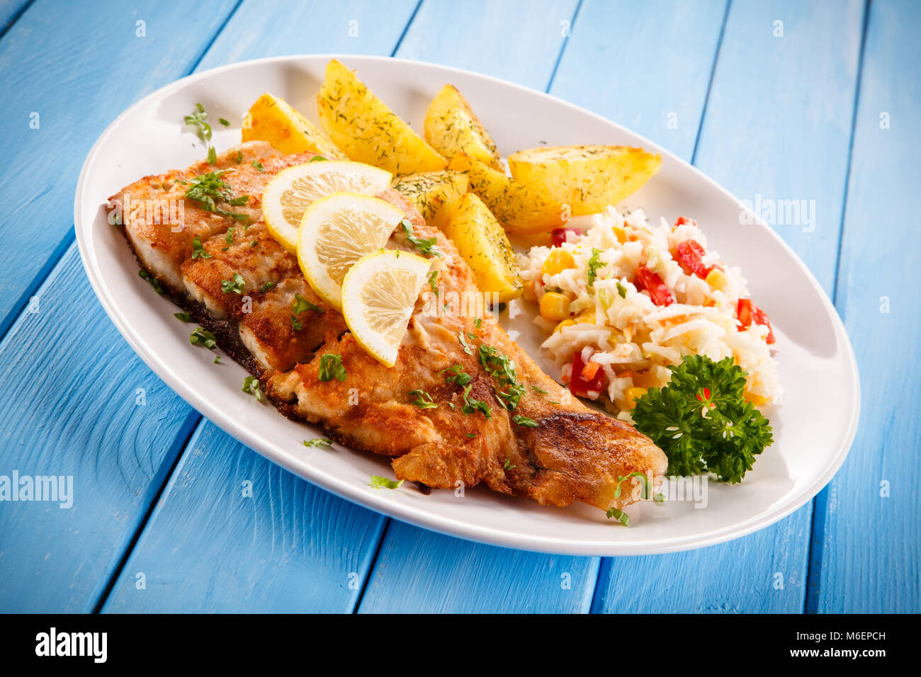 Fish dish - fried fish with potatoes Stock Photo - Alamy