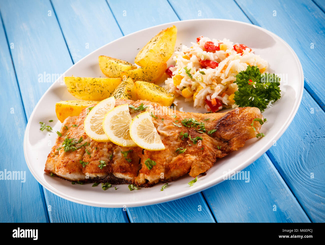 Fish dish - fried fish with potatoes Stock Photo - Alamy