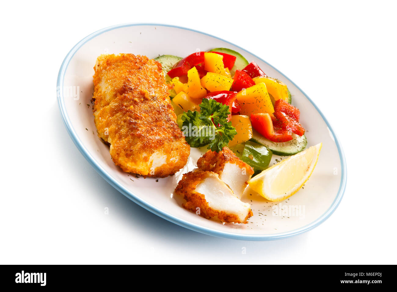Fish dish - fried fish fillets and vegetables Stock Photo - Alamy