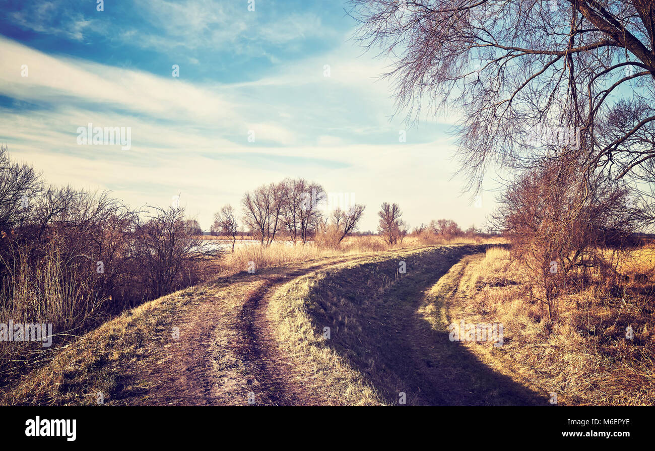Retro toned picture of a rural landscape with a walking path Stock ...